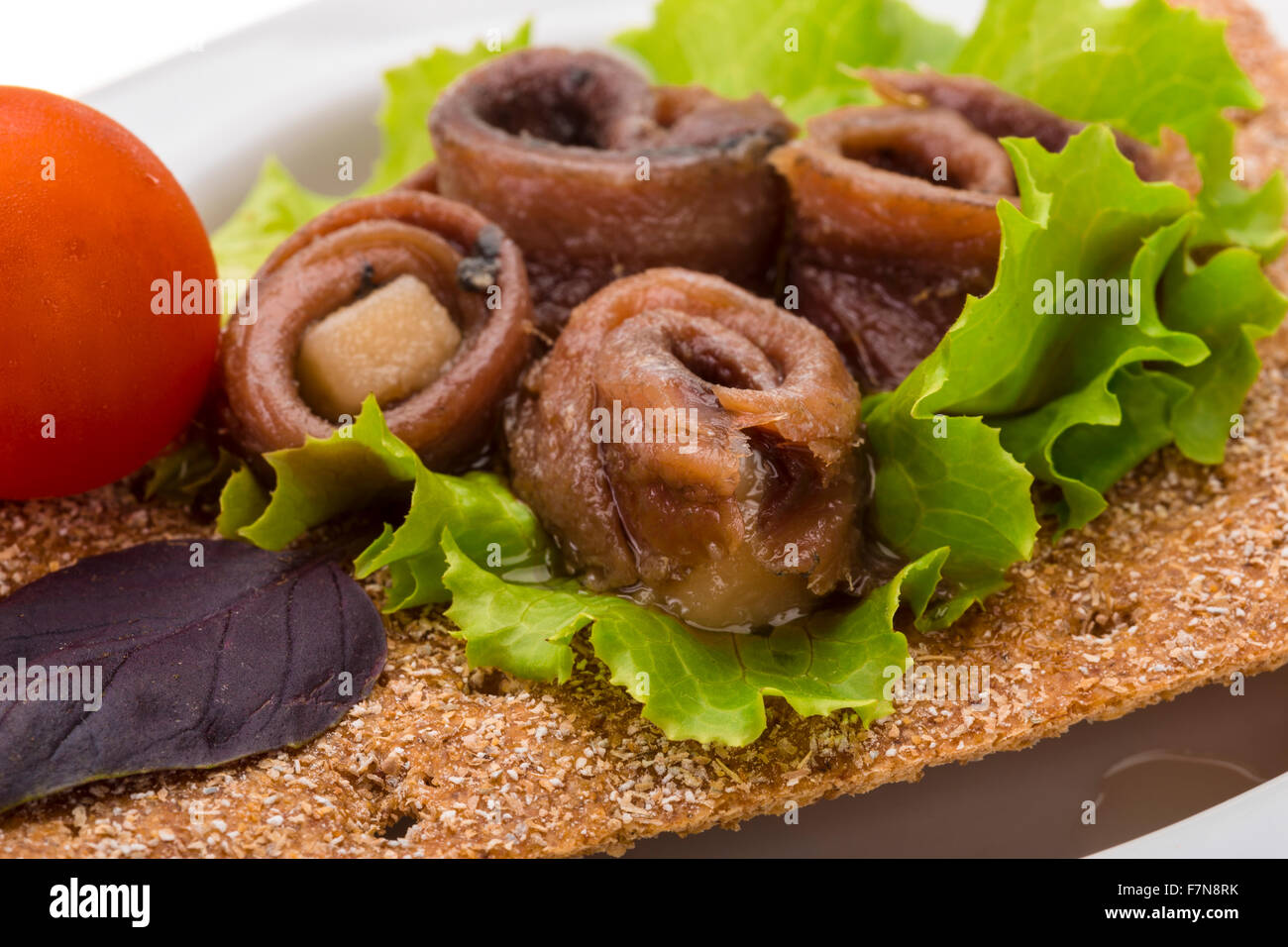 Anchovy snack with salad and tomato Stock Photo - Alamy