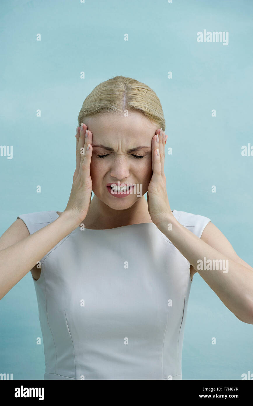 Woman outdoors headache holding head hi-res stock photography and ...