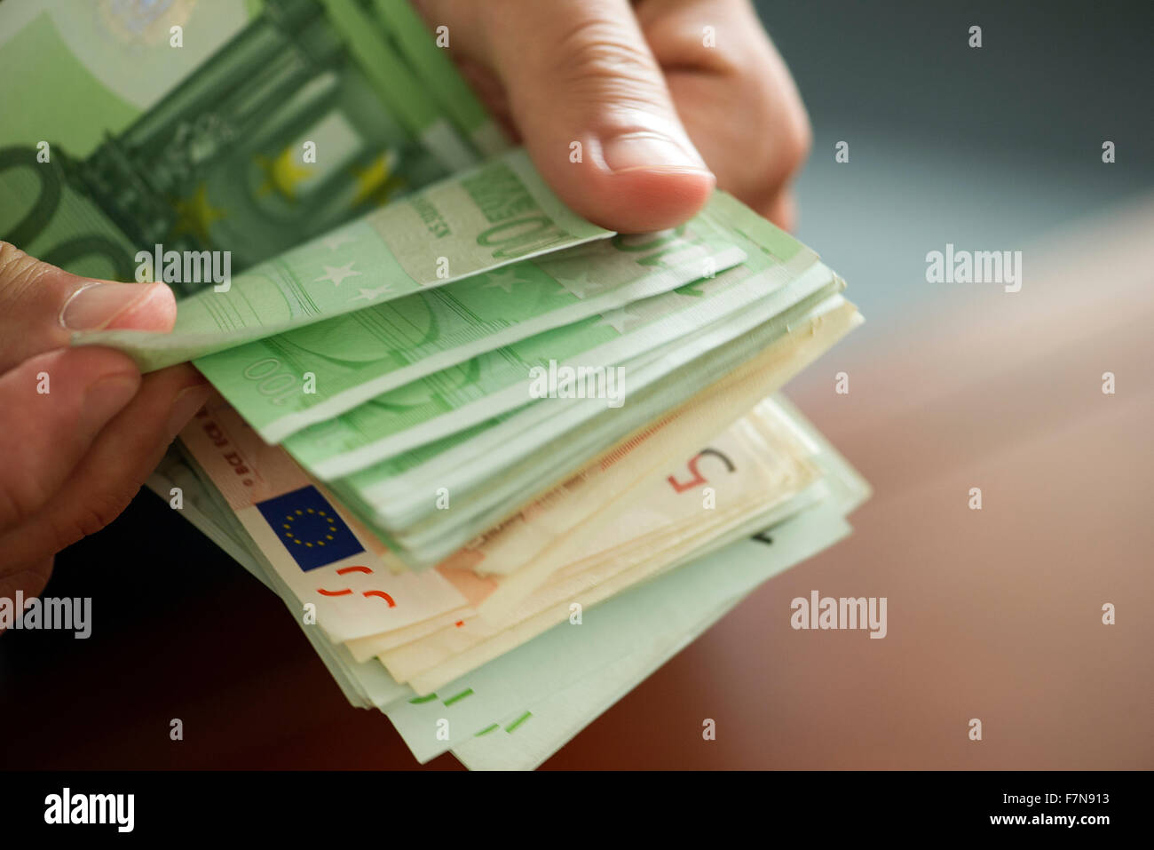 Hands countong stack of money, cropped Stock Photo - Alamy