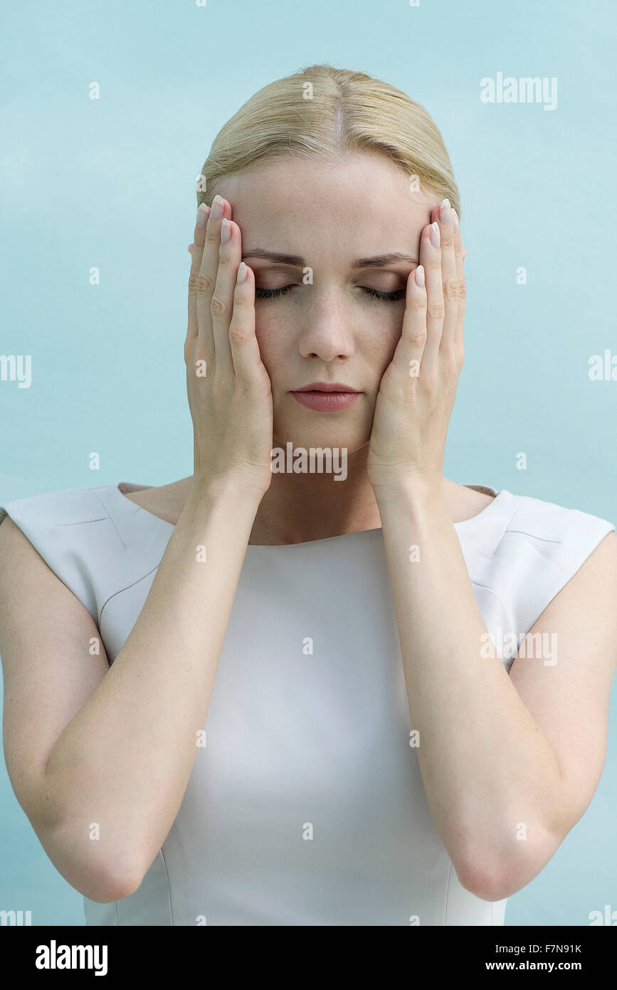 Woman with hands on face, eyes closed Stock Photo - Alamy