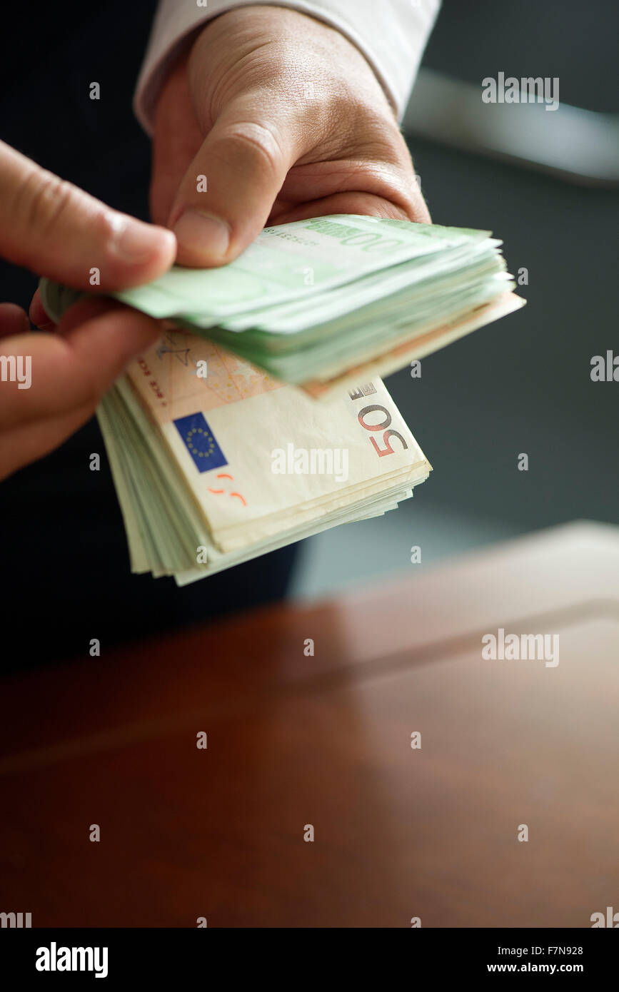 Man counting stack of cash, cropped Stock Photo - Alamy