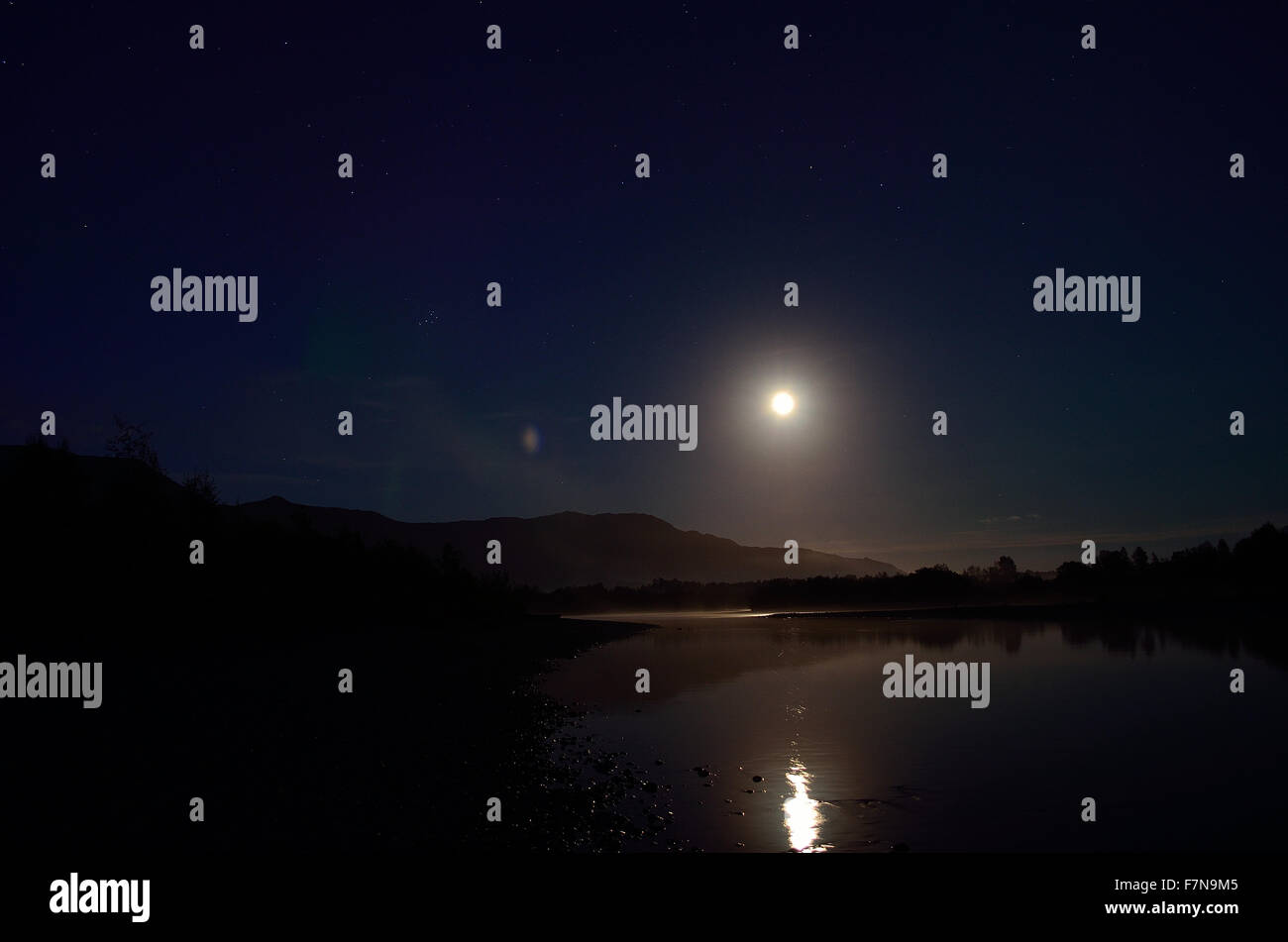 full moon river landscape at night surrounded by mountains Stock Photo ...