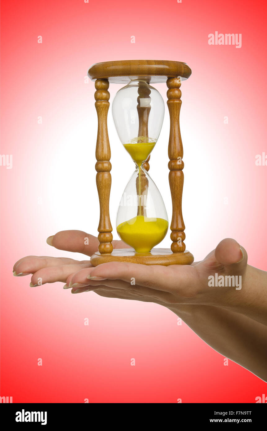 Hand holding hourglass on white Stock Photo - Alamy