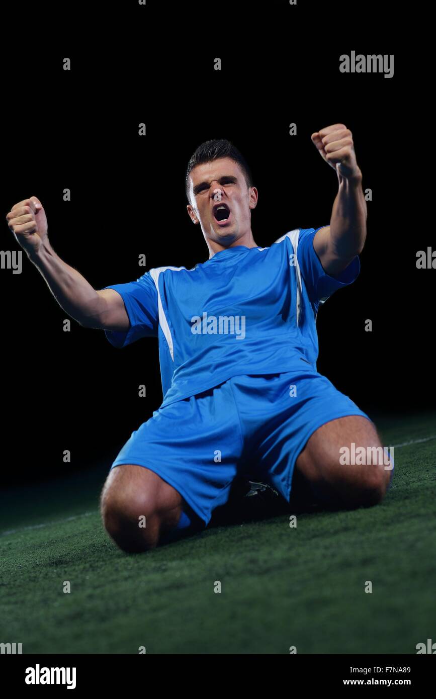 soccer player doing kick with ball on football stadium field isolated ...