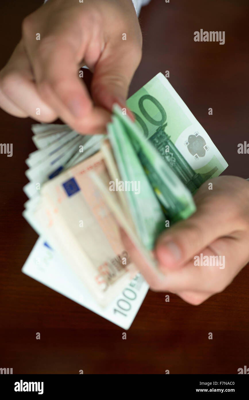 Hands counting stack of cash Stock Photo - Alamy