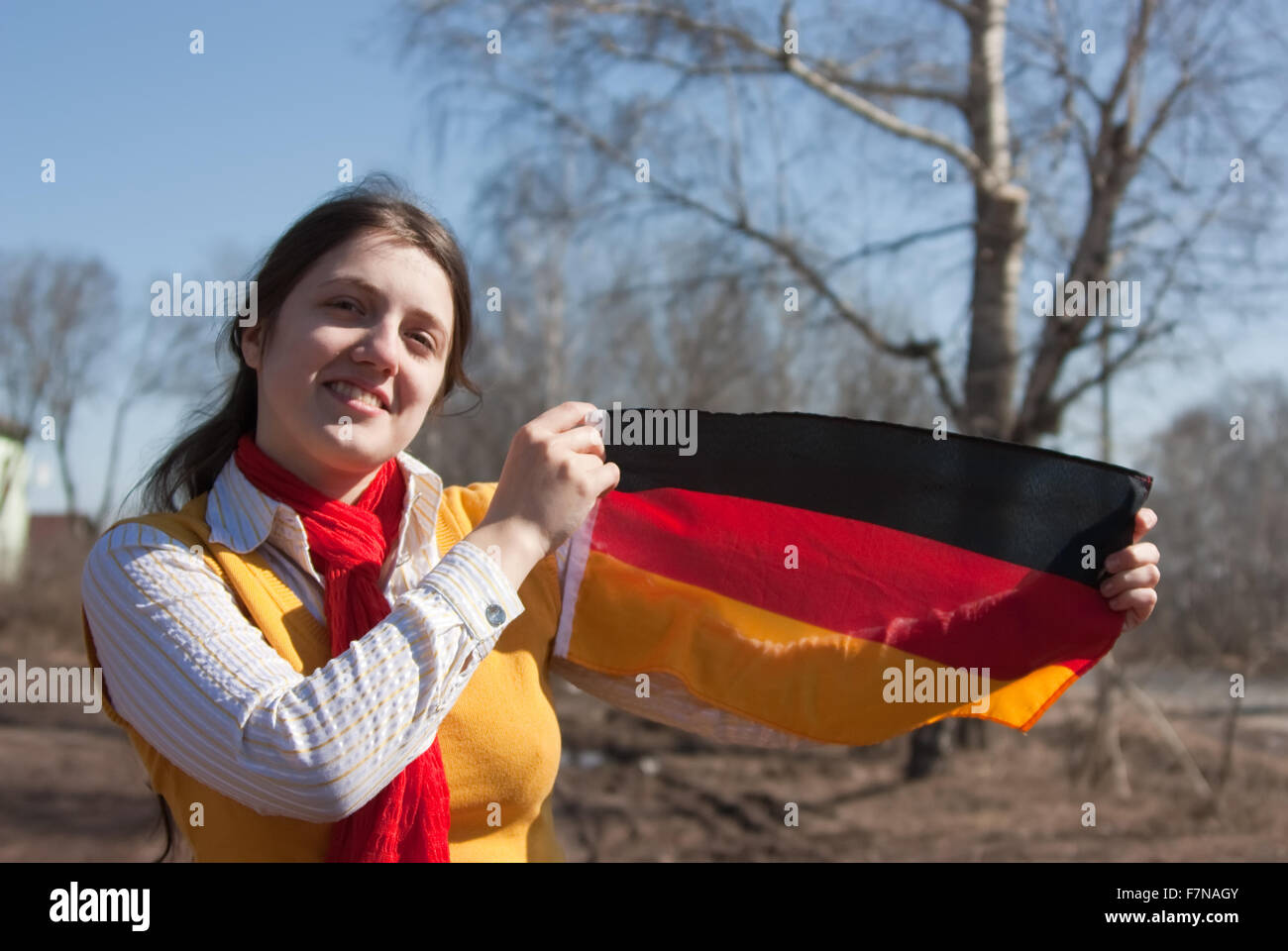 Girl is holding the germany flag outdoor Stock Photo - Alamy