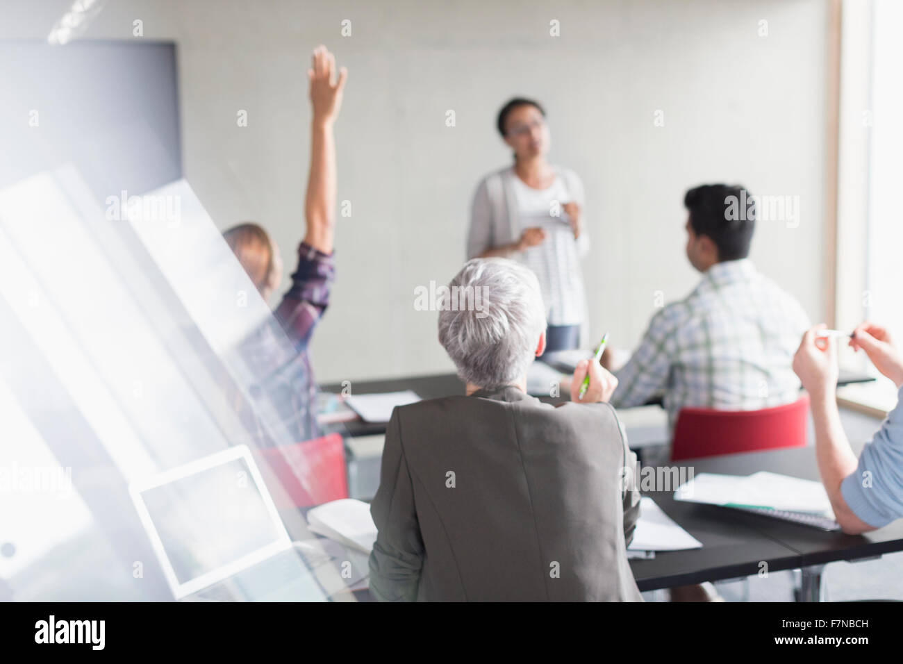 Teacher and students in adult education classroom Stock Photo - Alamy