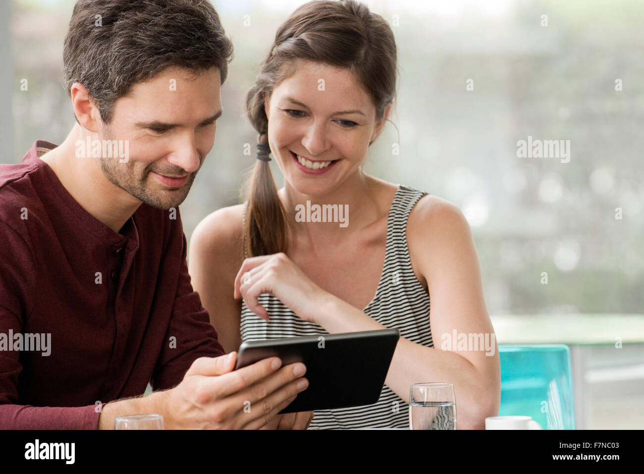 Digital tablets allow friends to easily share photos Stock Photo - Alamy