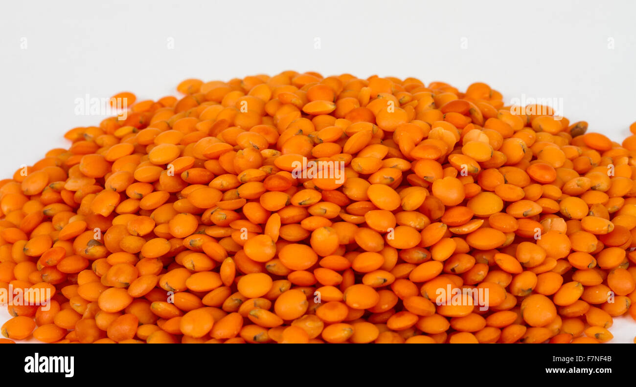 Heap of raw red lentils isolated on white background Stock Photo - Alamy