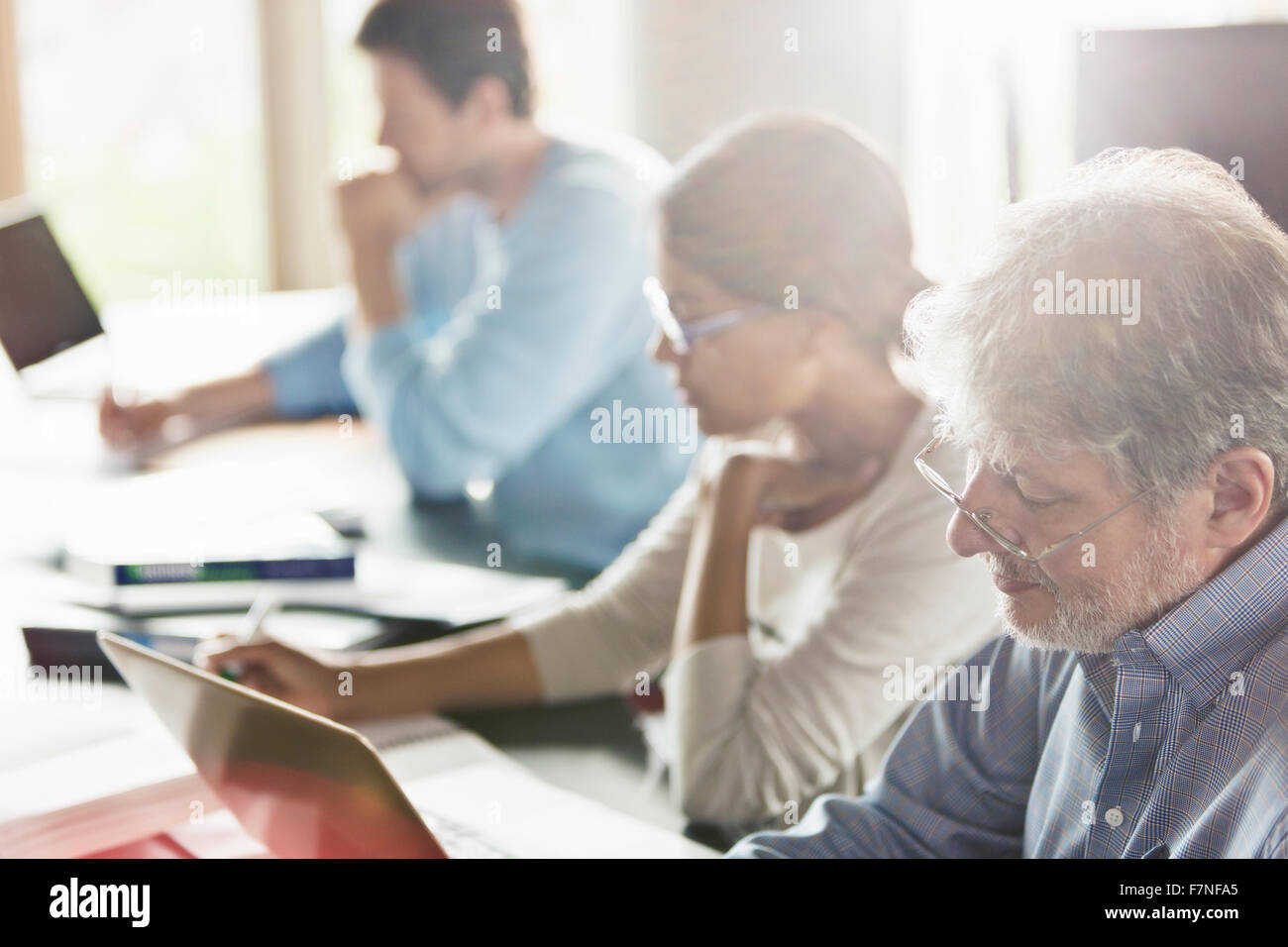 Students studying in adult education classroom Stock Photo - Alamy