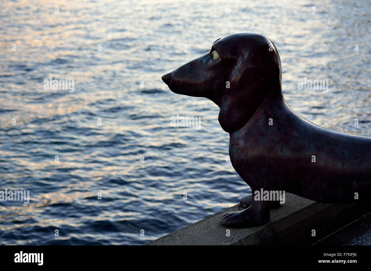 Beautiful dog sculpture watching out over the harbour Stock Photo - Alamy