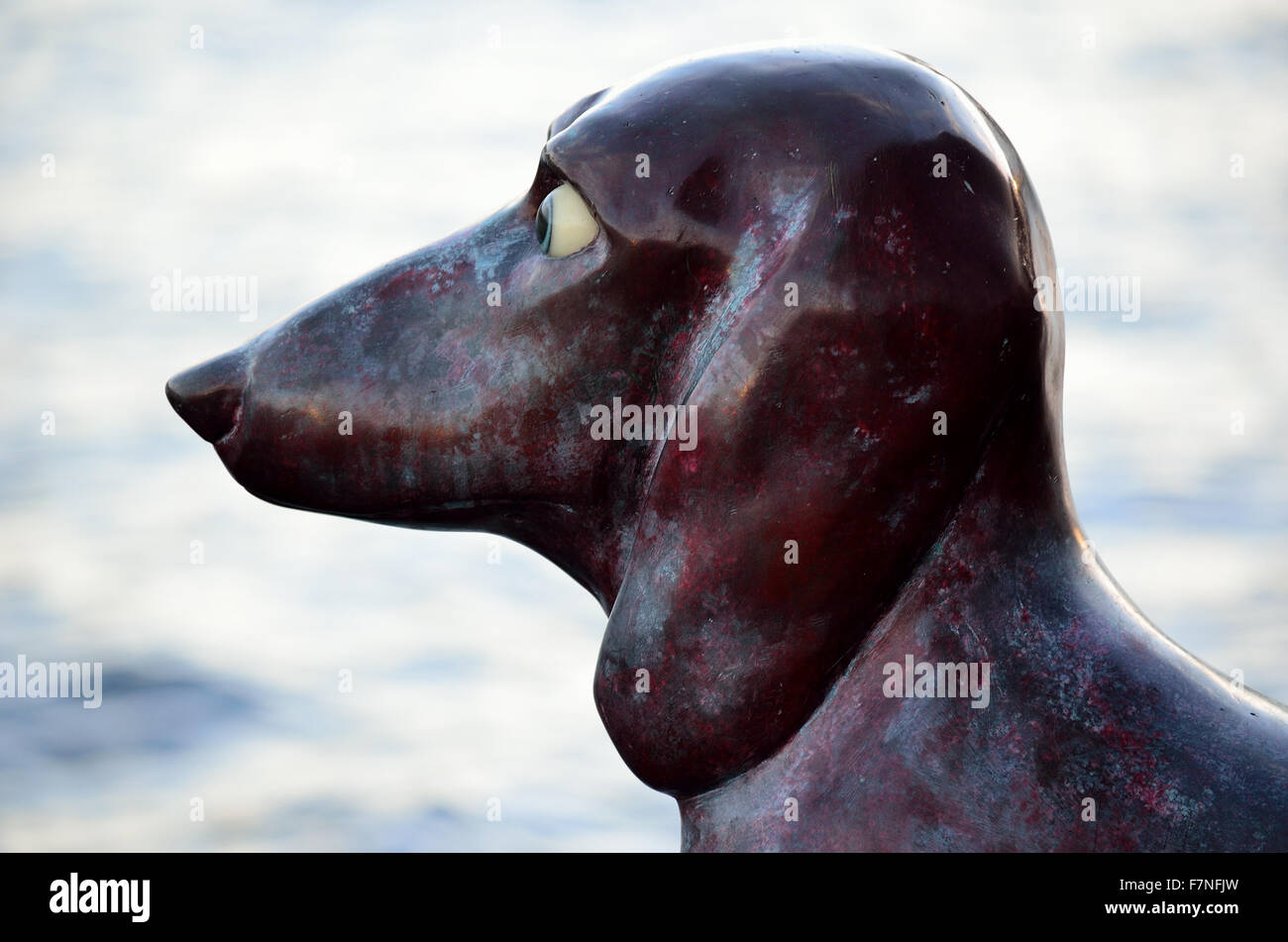 Beautiful dog sculpture watching out over the harbor Stock Photo - Alamy