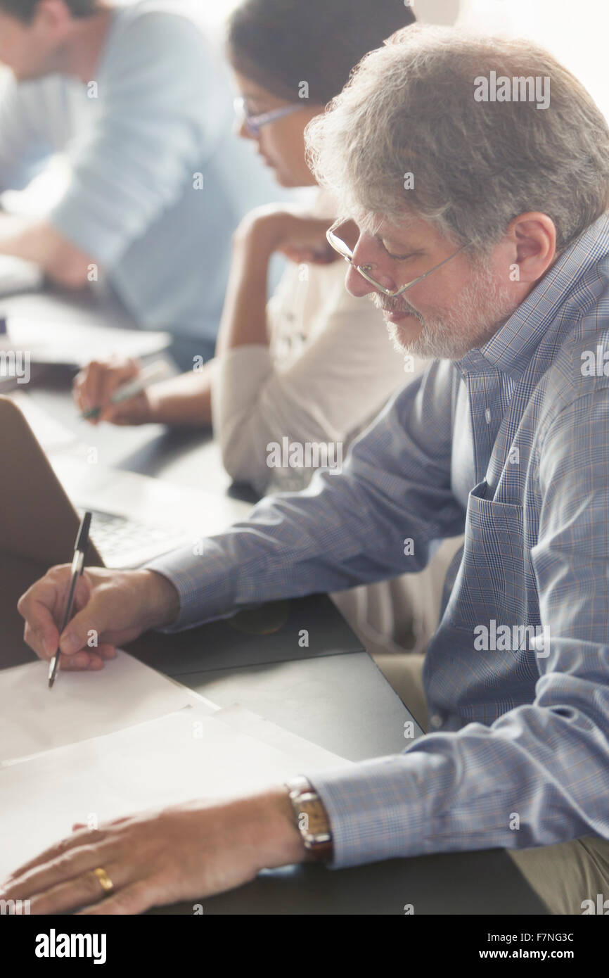 Man doing homework in adult education classroom Stock Photo - Alamy