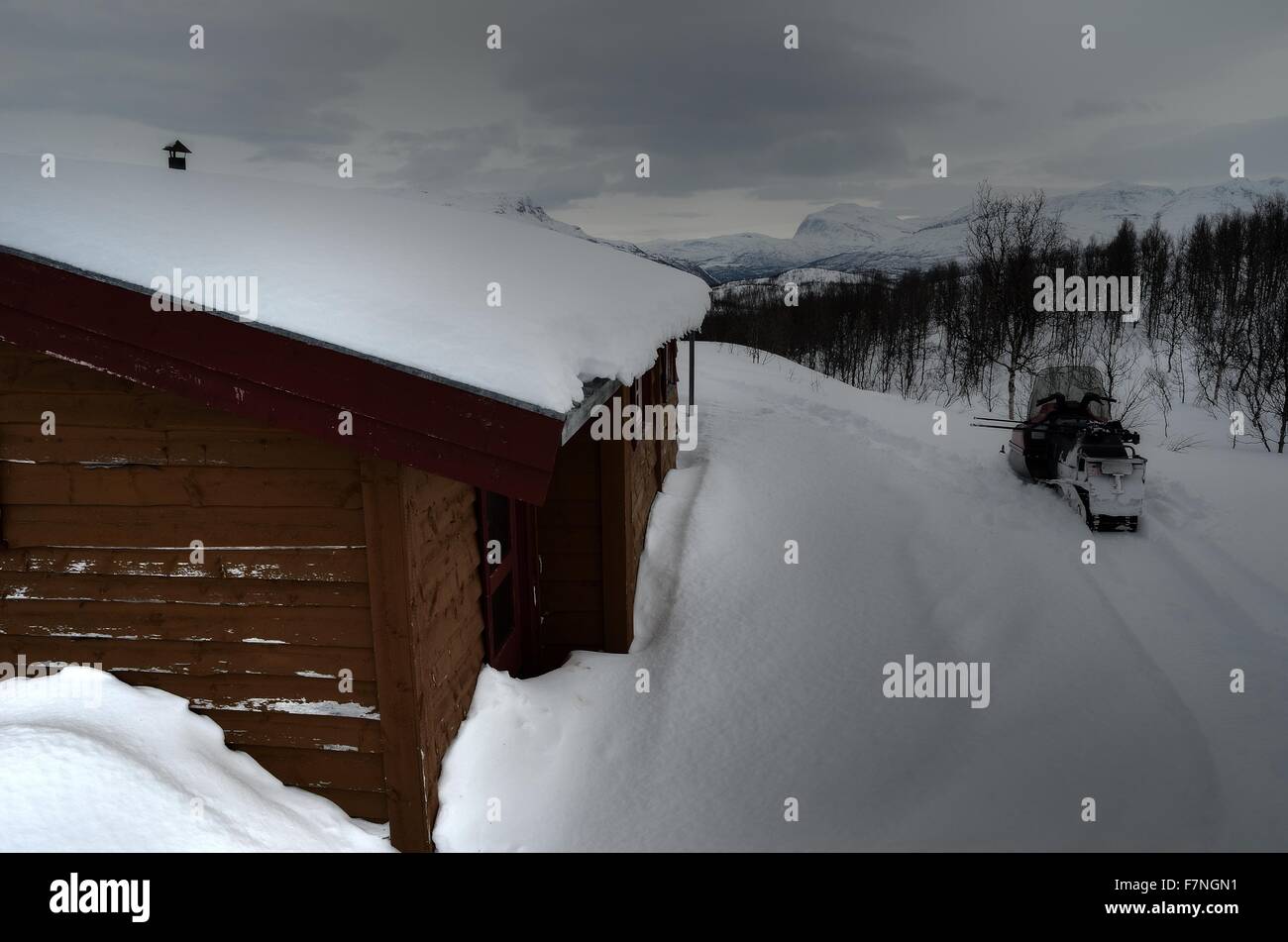 snow covered mountain cabin and snowmobile Stock Photo - Alamy