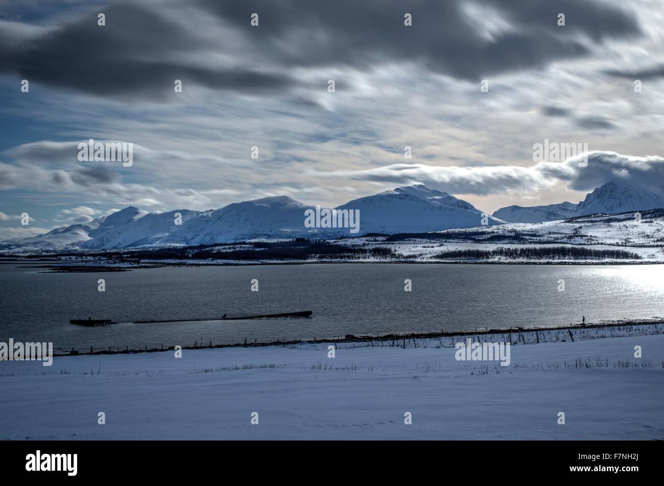 blue winter landscape with snowy mountain and clear cold crisp fjord ...