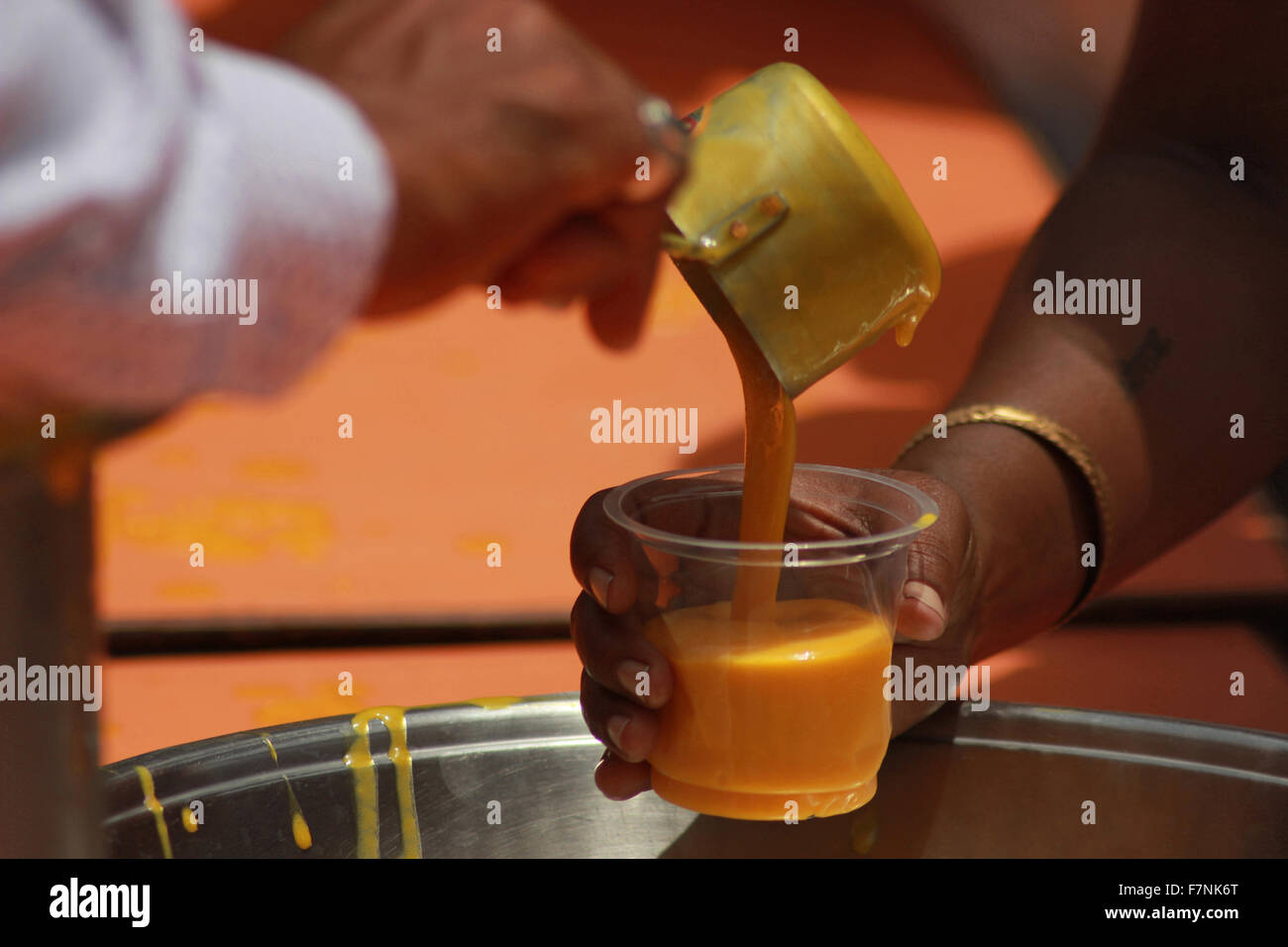 Man serving mango juice Stock Photo - Alamy