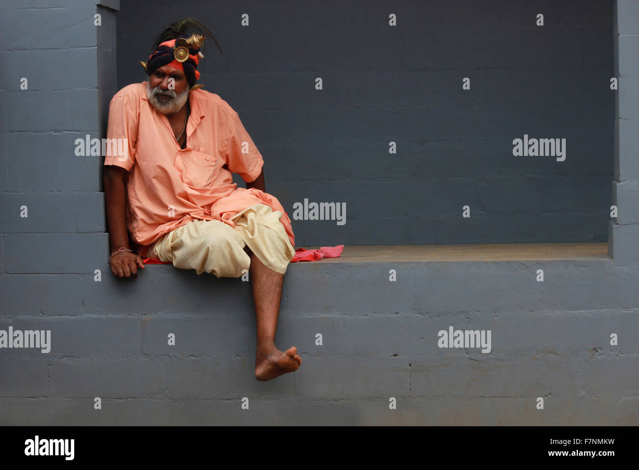 Pilgrim sitting on wall Kumbh Mela, Nasik, Maharashtra, India Stock ...