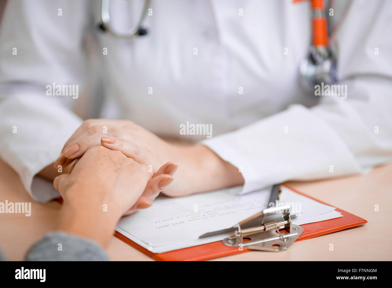 Doctor consoling or supporting patient Stock Photo - Alamy