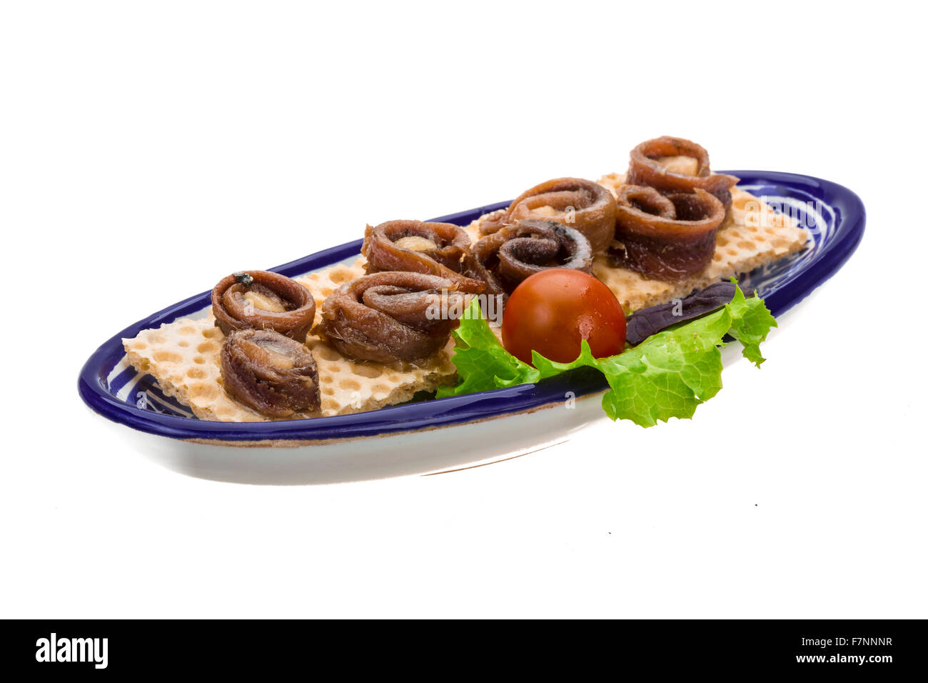 Anchovy snack with salad and tomato Stock Photo - Alamy