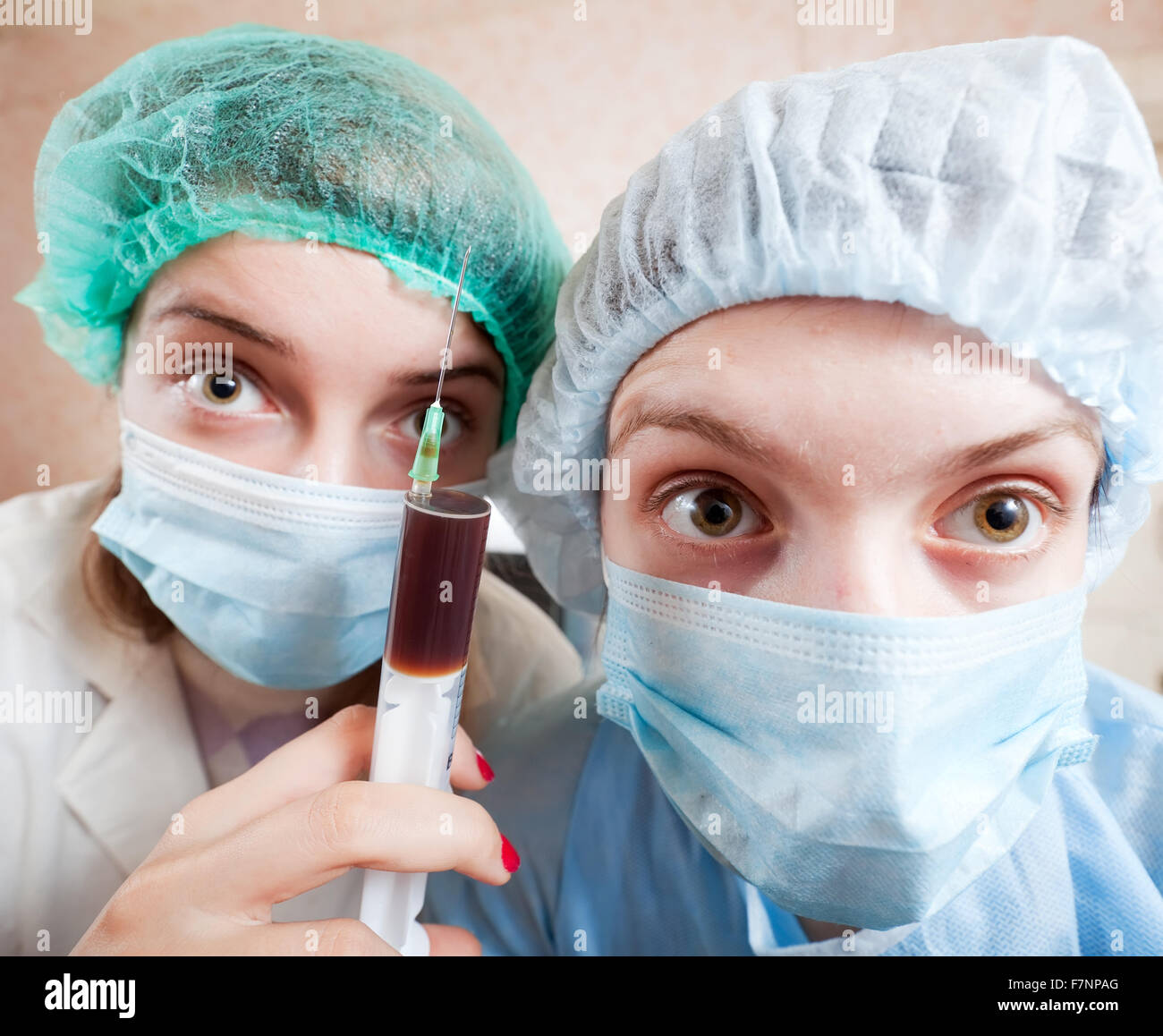 wide angle shot of two young doctors with syringe Stock Photo - Alamy