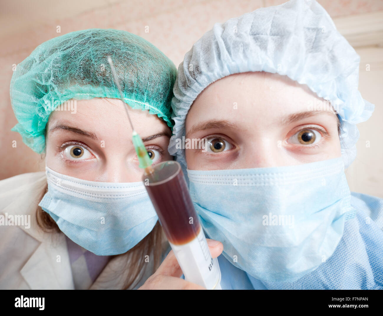 wide angle shot of two young doctors with syringe Stock Photo - Alamy