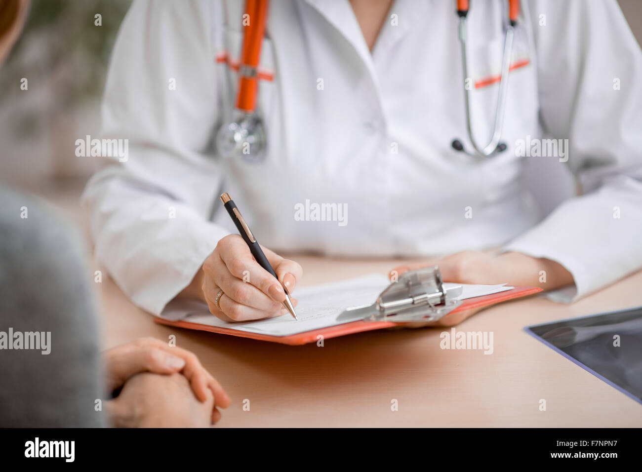 Doctor or physician writing diagnosis Stock Photo - Alamy