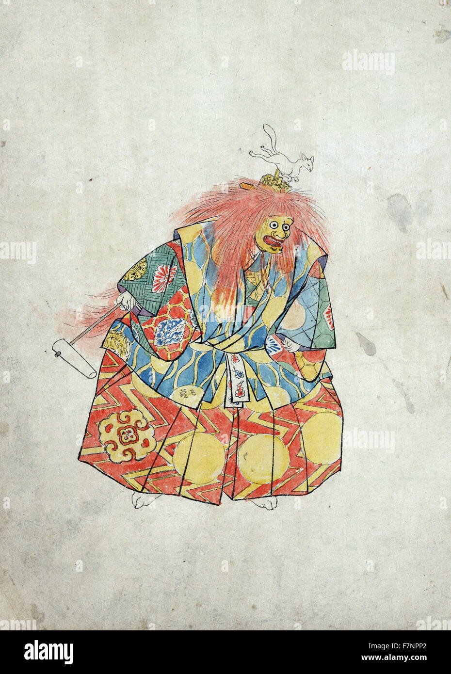 A clown wearing colourful costume and mask, with wild hair and hat with ...