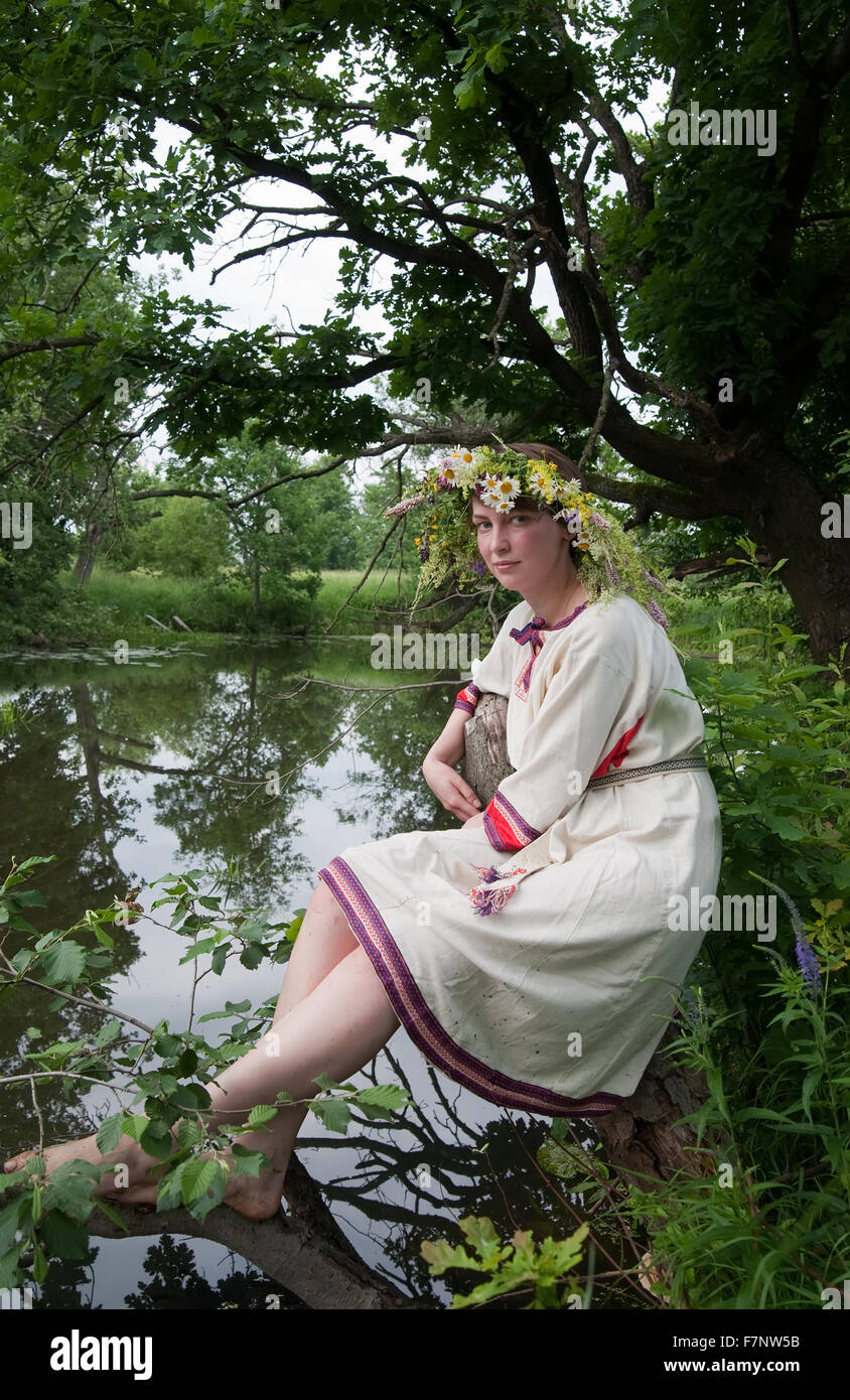 girl in flowers wreath and traditional clothes Stock Photo - Alamy