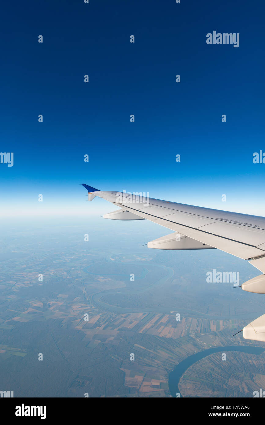 Airplane wing out of window Stock Photo - Alamy