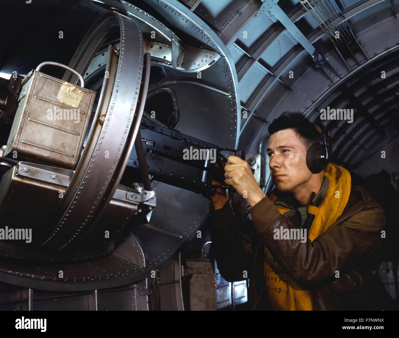 American airman using a a side machine gun of a B-17 Flying Fortress ...