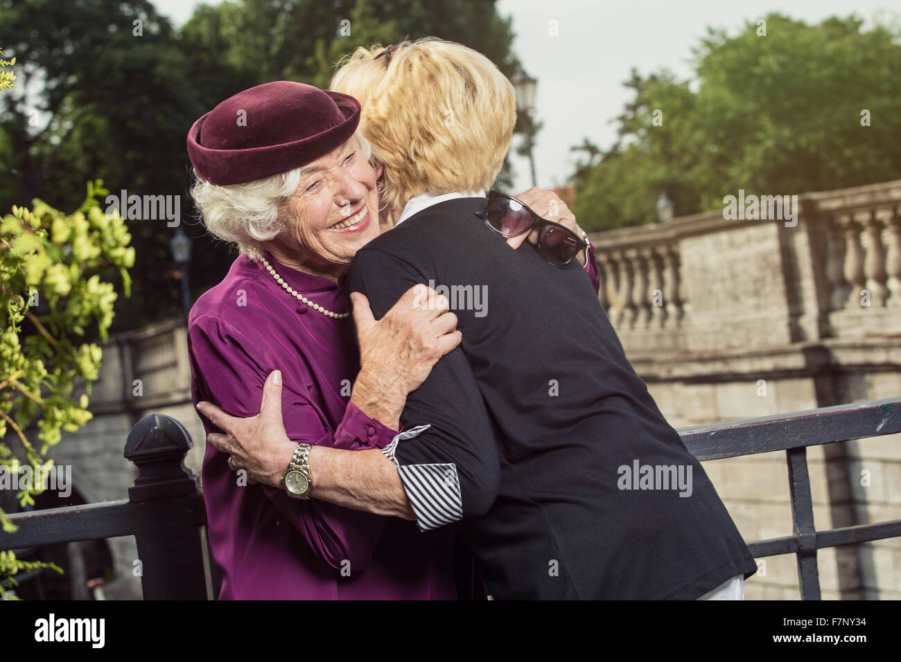 Germany, Berlin, portrait of two happy senior women hugging each other ...
