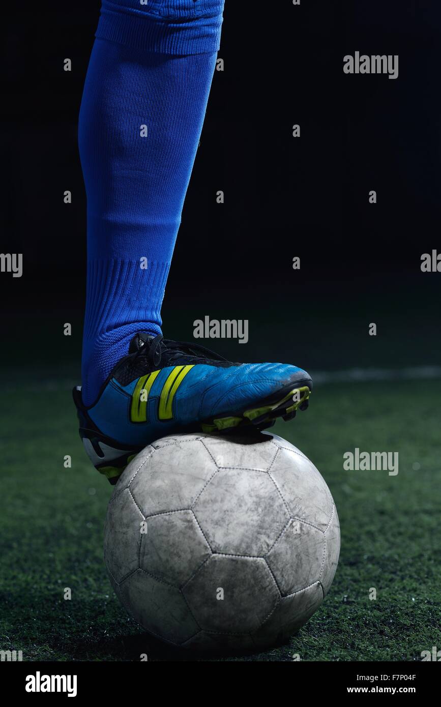 soccer player doing kick with ball on football stadium field isolated ...