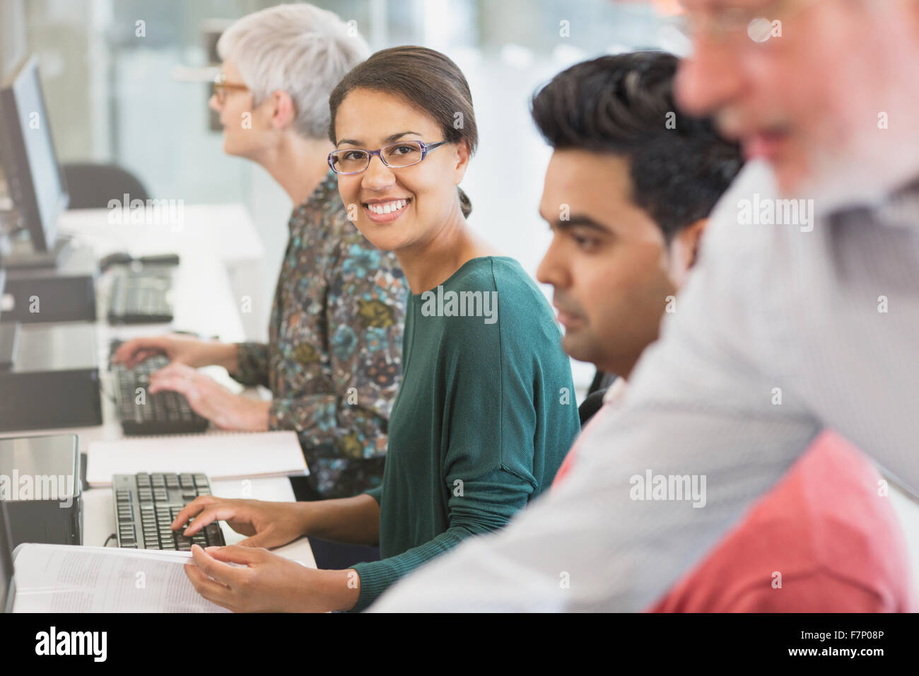 Portrait smiling woman at computer in adult education classroom Stock ...