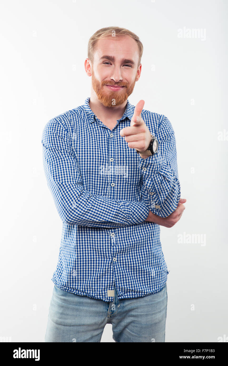 Portrait of a happy casual man showing gun gesture at camera isolated ...