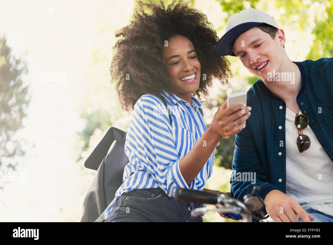 Friends texting with cell phone Stock Photo - Alamy
