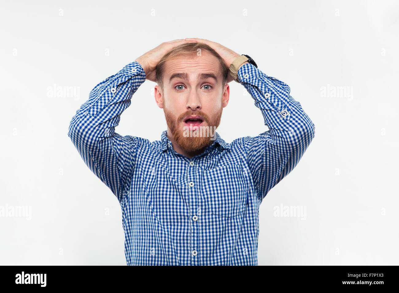 Portrait of a shocked man looking at camera isolated on a white ...