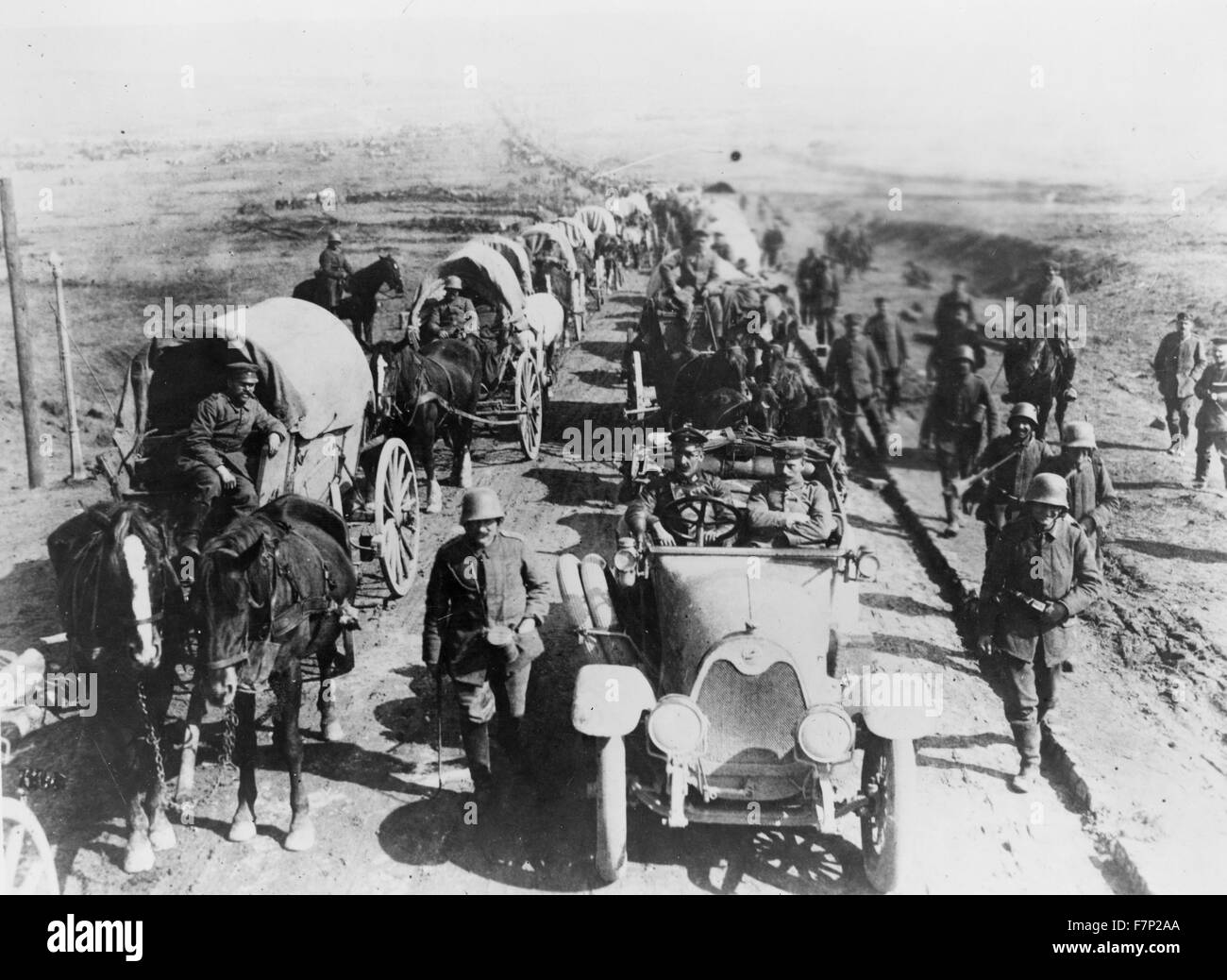 German officers in an automobile, with a convoy of wagons;World war one ...
