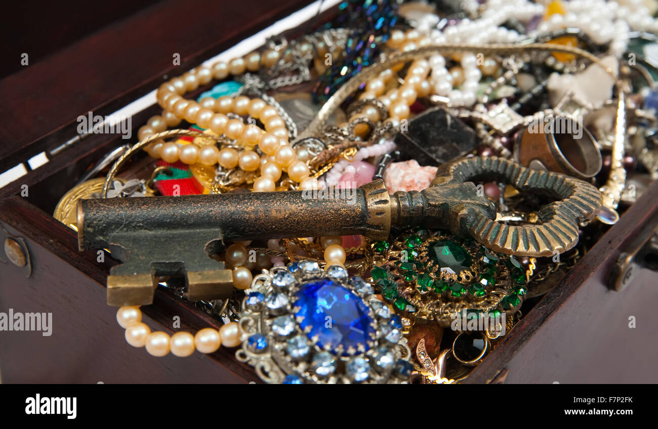 wooden treasure chest with valuables and key. Focus on key Stock Photo ...