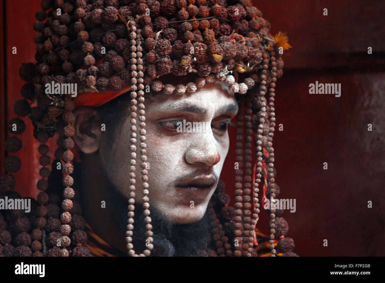 Sadhu with painted face and heavy beads on head. Kumbh Mela, Nasik ...