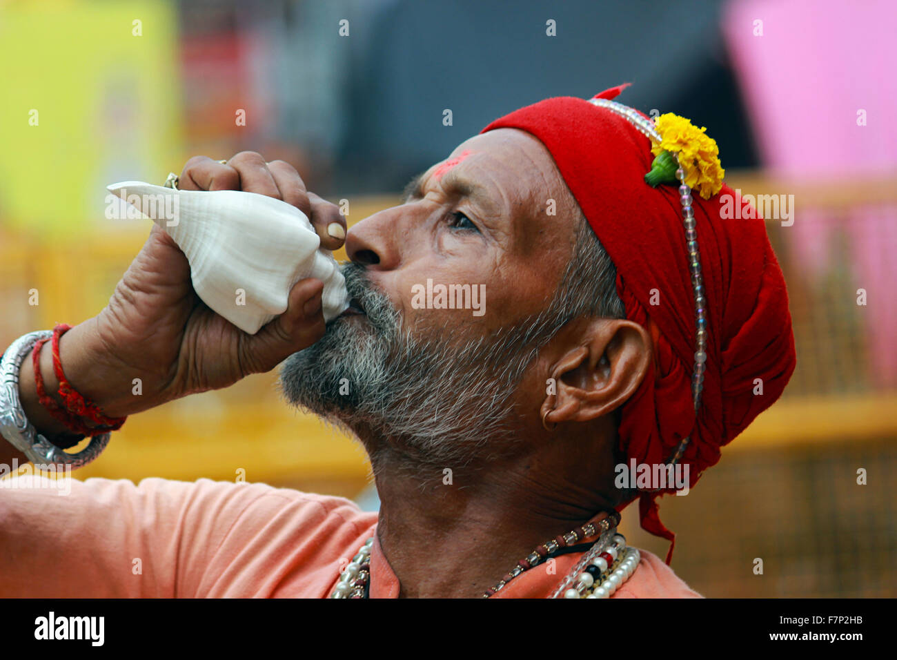 Man blowing conch shell hi-res stock photography and images - Alamy