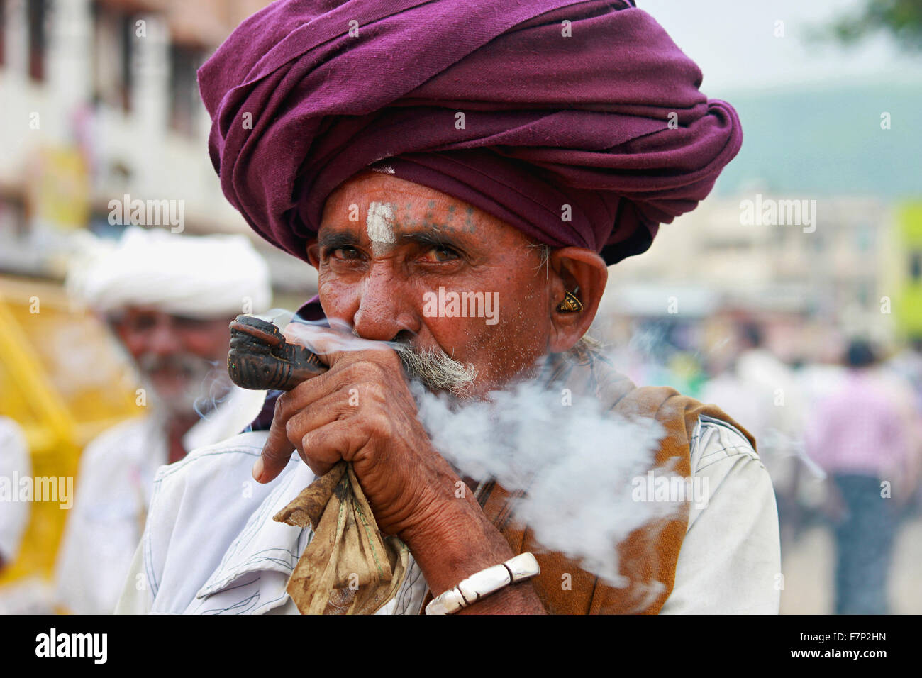 Man smoking chillum (clay pipe) Kumbh Mela, Nasik, Maharashtra, India ...