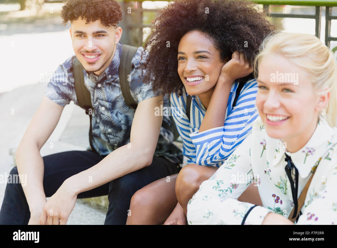 Smiling friends looking away Stock Photo - Alamy