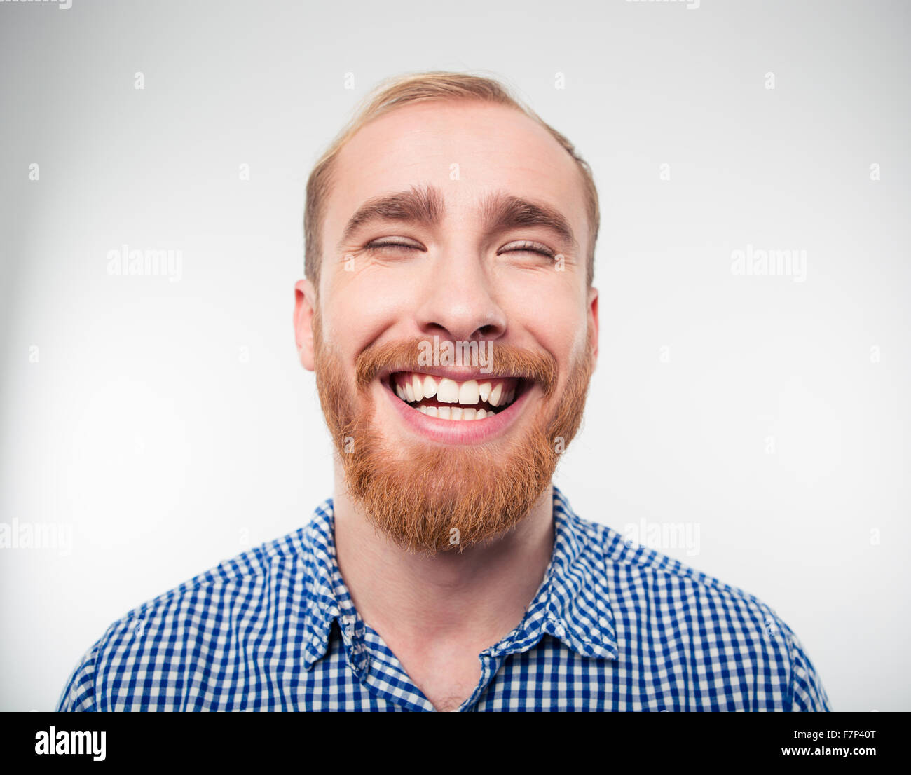 Closeup portrait of a casual man laughing isolated on a white ...