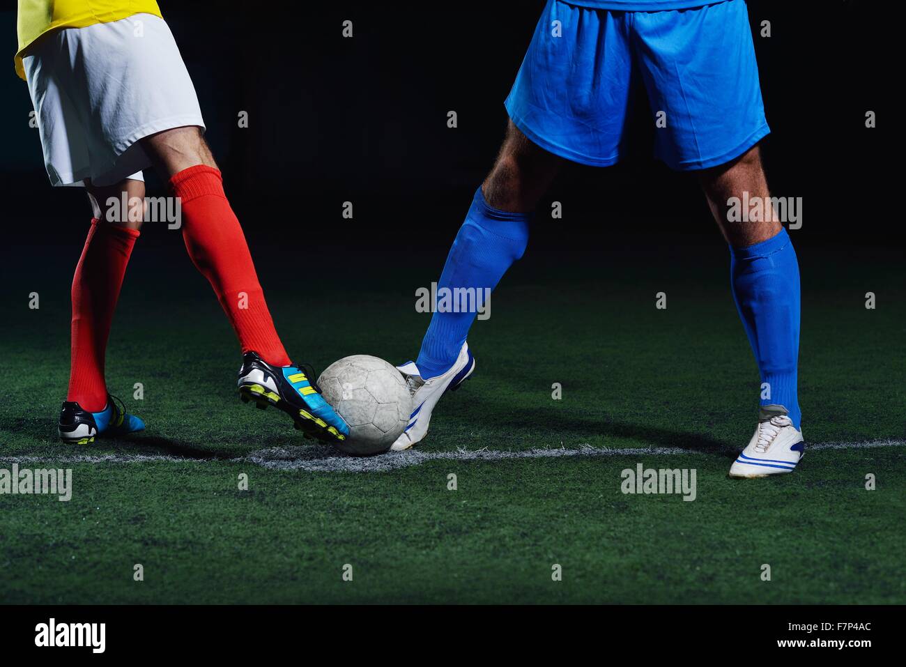 soccer player doing kick with ball on football stadium field isolated ...