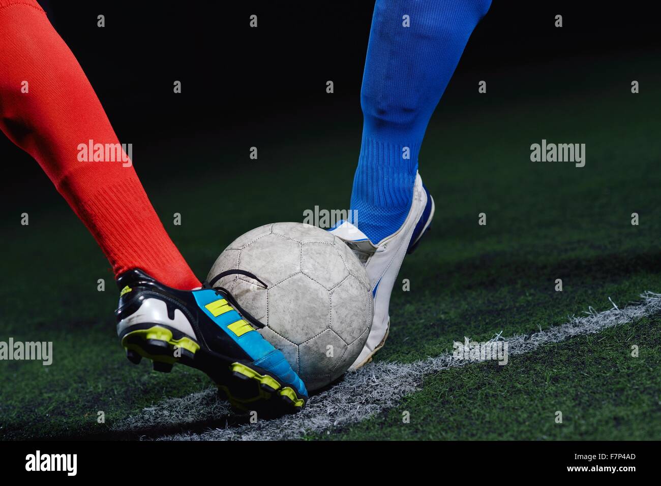 soccer player doing kick with ball on football stadium field isolated ...