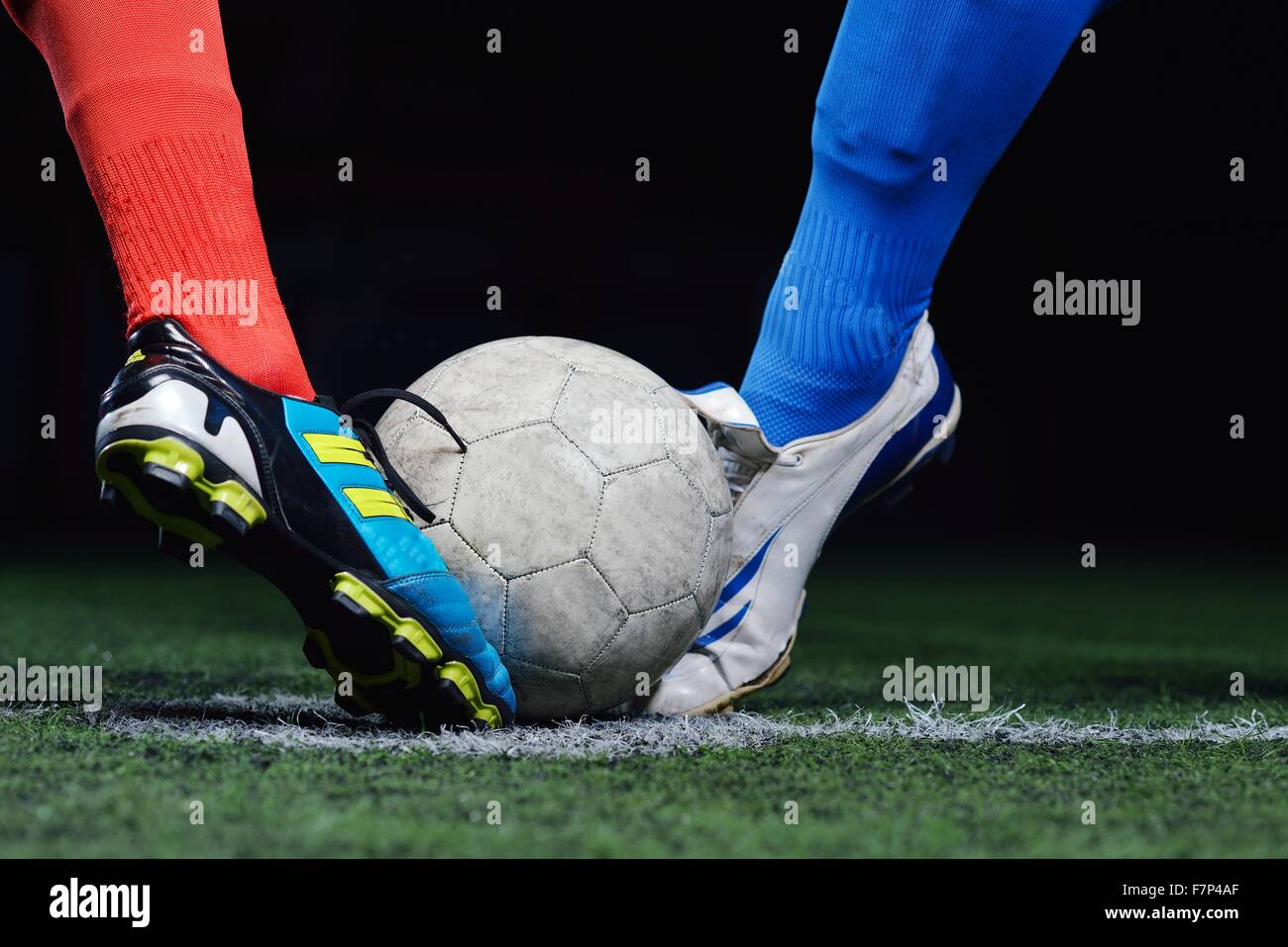 soccer player doing kick with ball on football stadium field isolated ...