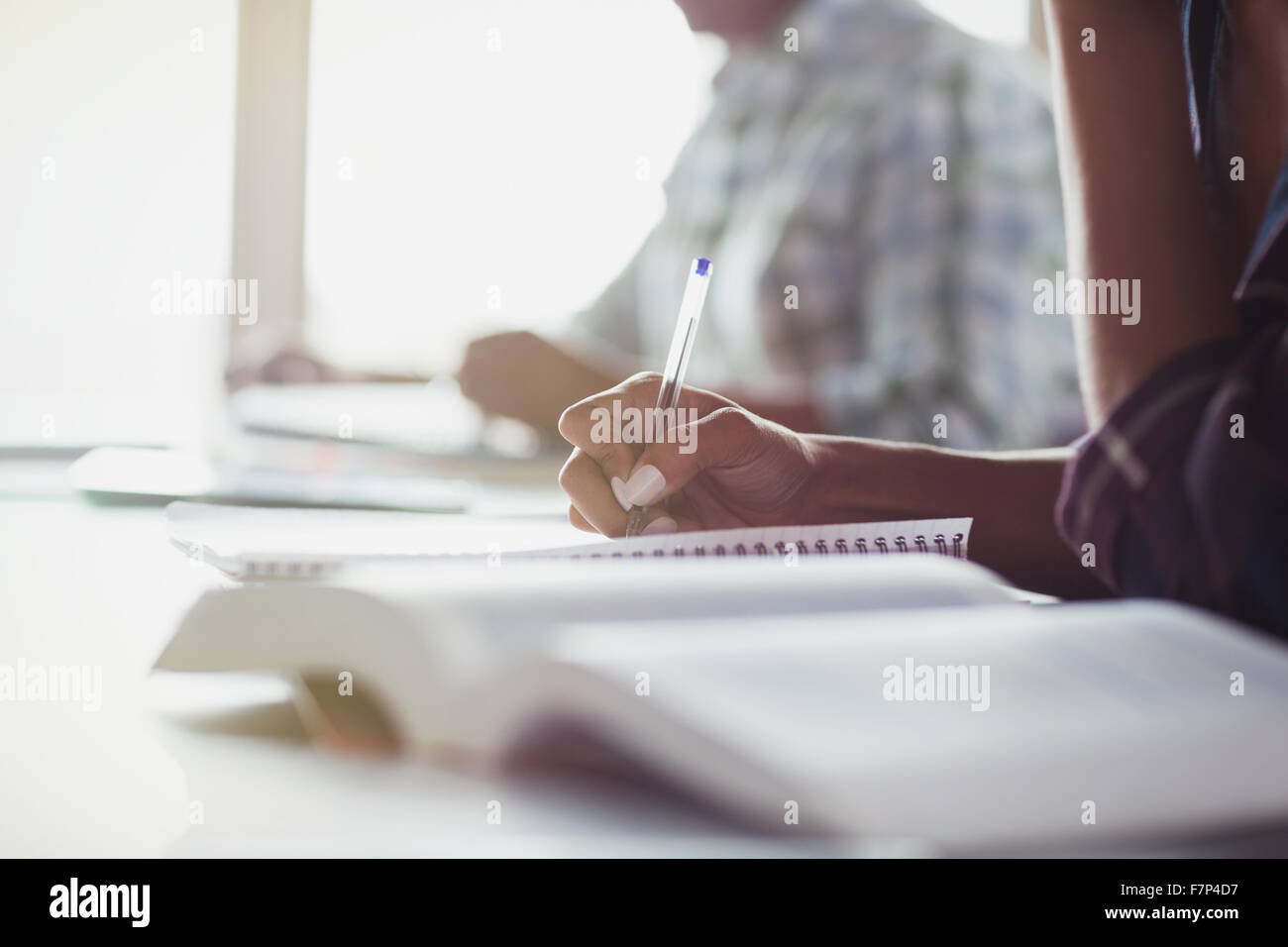 Students taking notes in adult education classroom Stock Photo - Alamy