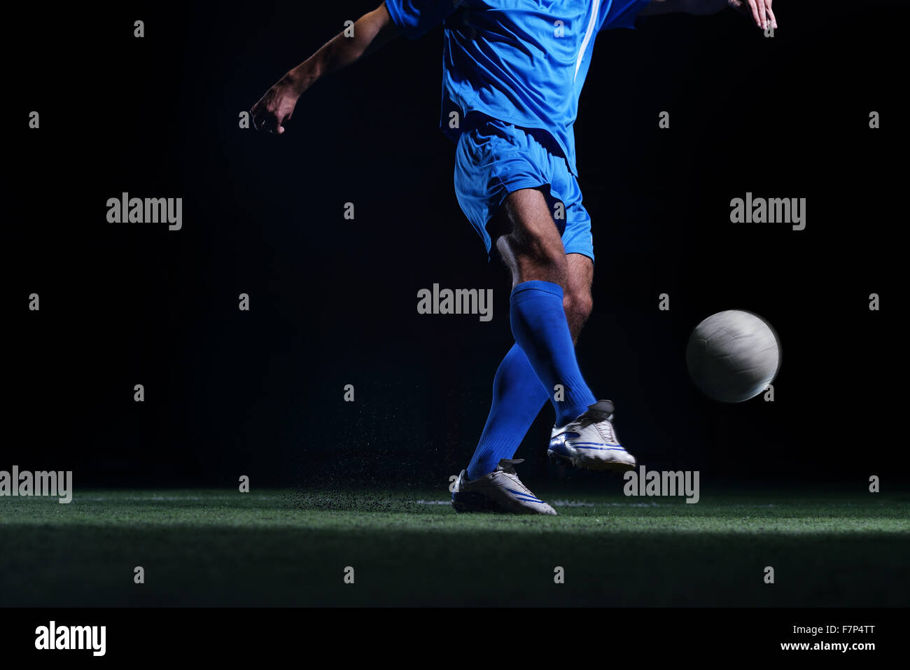 soccer player doing kick with ball on football stadium field isolated ...