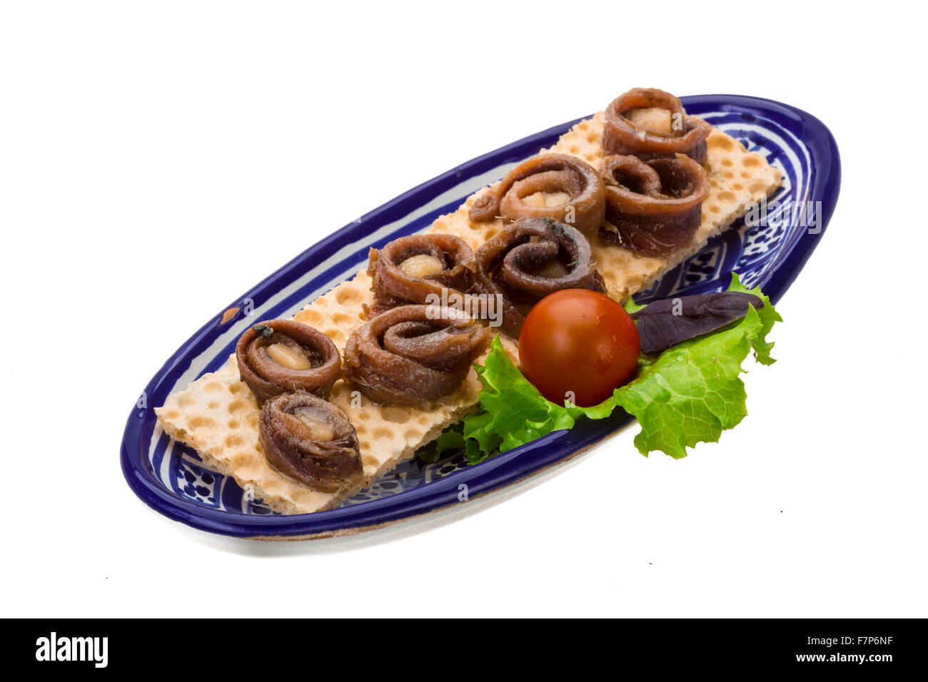 Anchovy snack with salad and tomato Stock Photo - Alamy