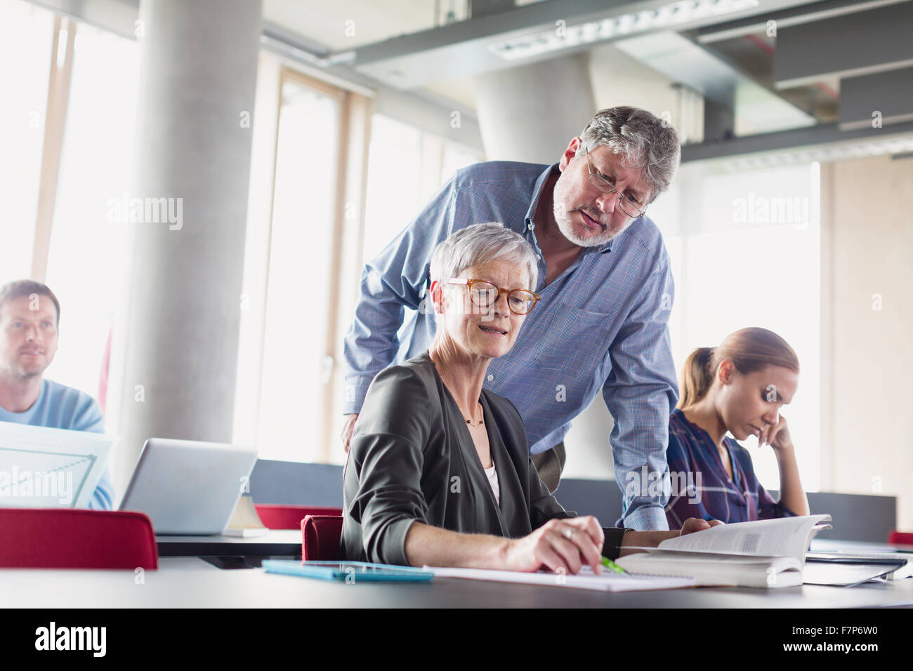 Students discussing homework in adult education classroom Stock Photo ...